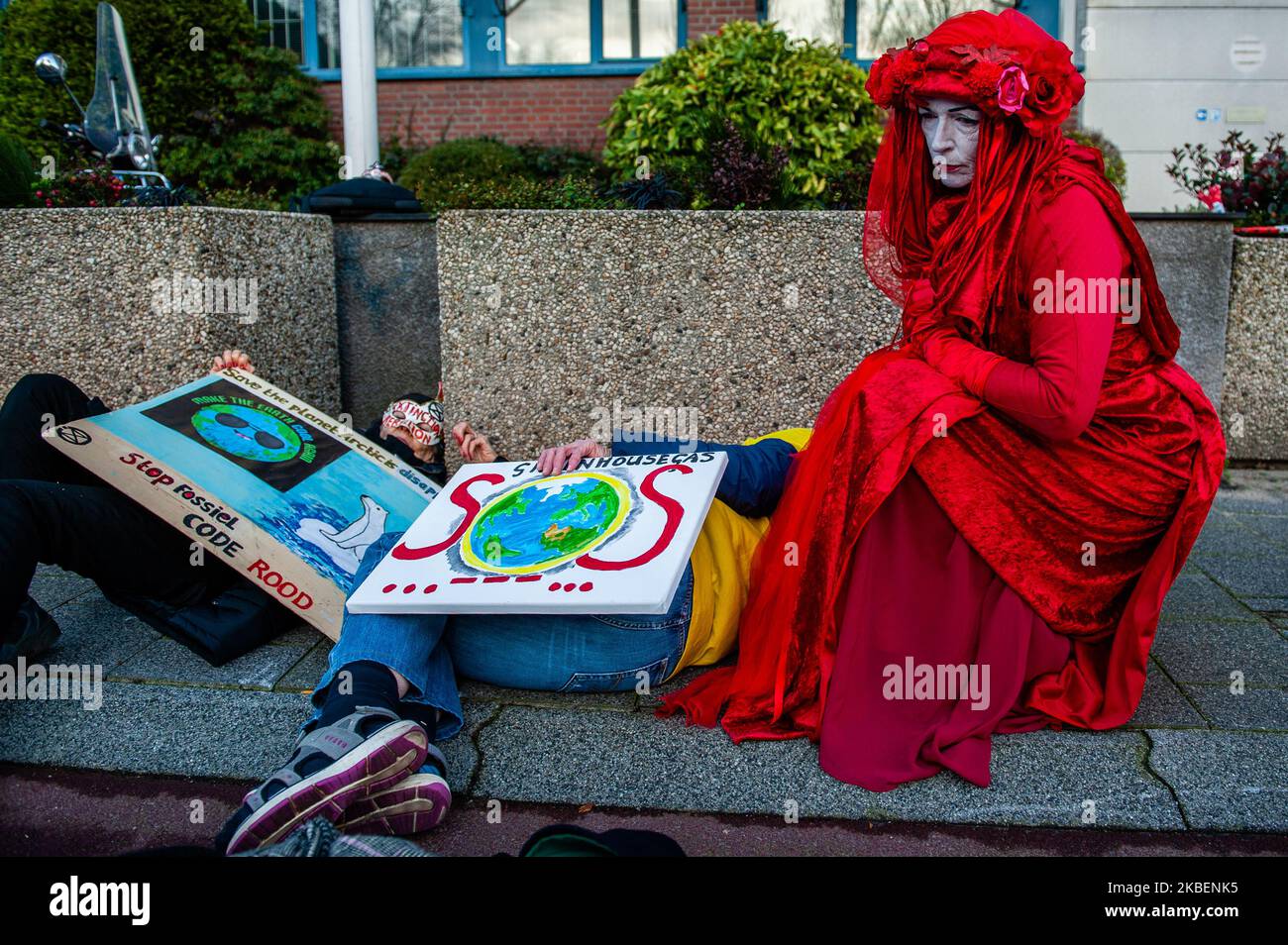 XR activists and the Red Rebel Brigade are performing a Die-In action ...