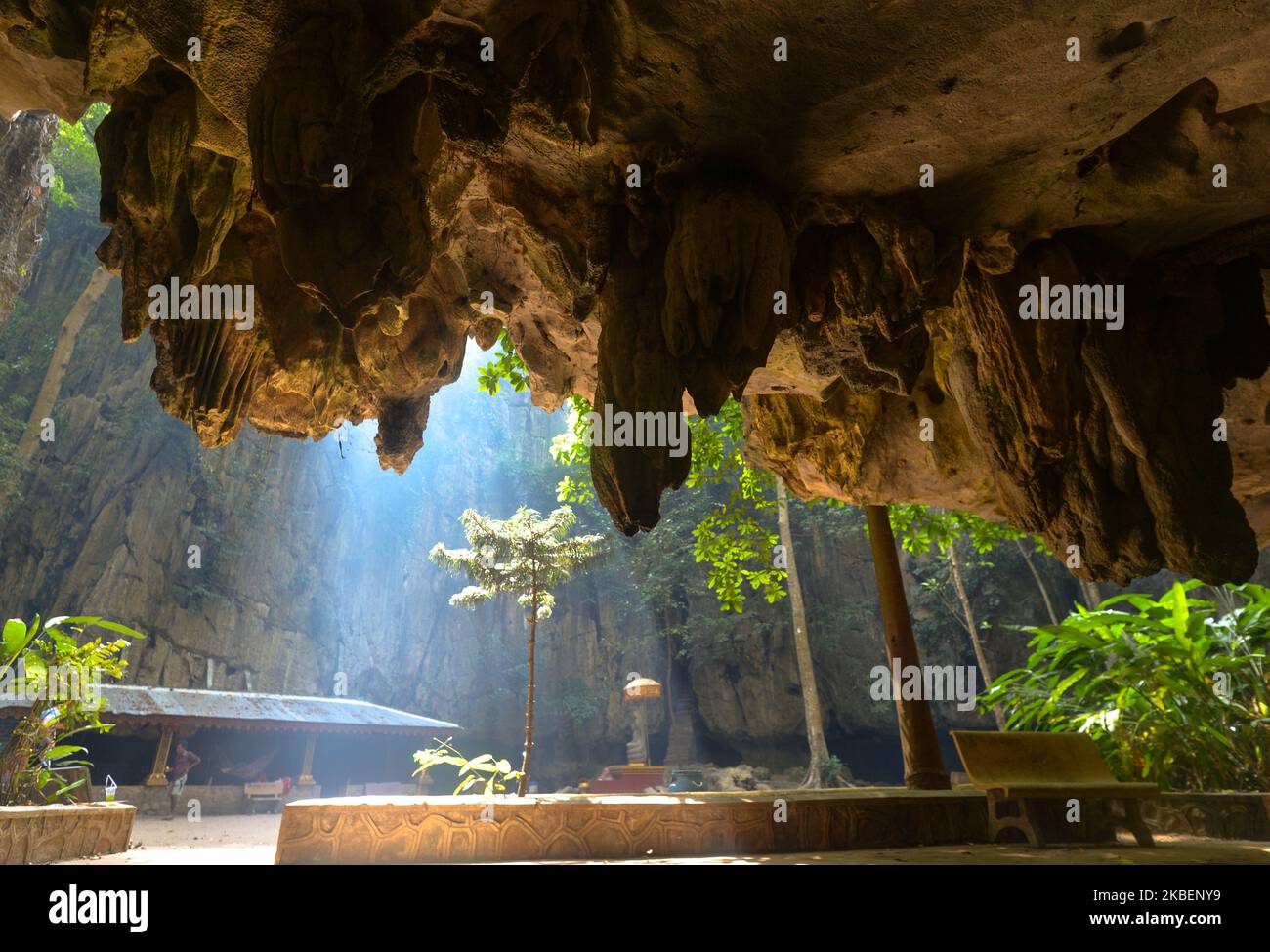 A view of Phnom Kampong Tranch. The roof of a large cave in the center ...