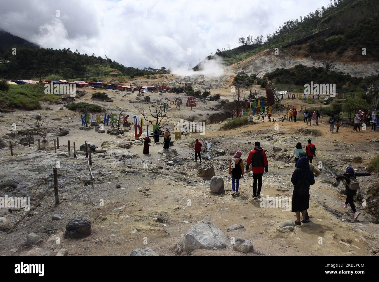 Tourists are at Sikidang Dieng Crater, one of the popular tourist ...