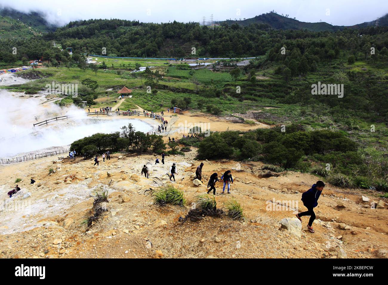 Tourists are at Sikidang Dieng Crater, one of the popular tourist ...