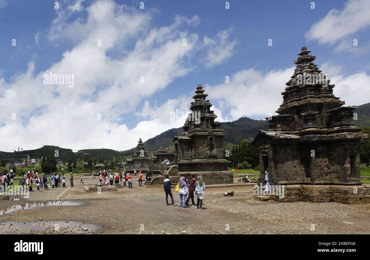 Tourists are in the Arjuna Temple complex, a Hindu temple building ...