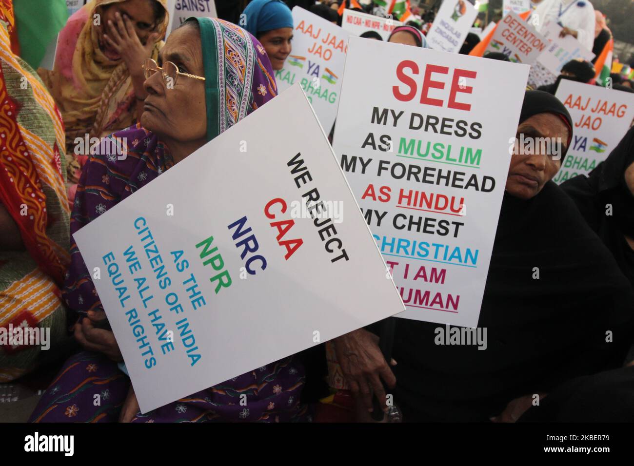 Demonstrators hold placards during a protest against Citizenship ...