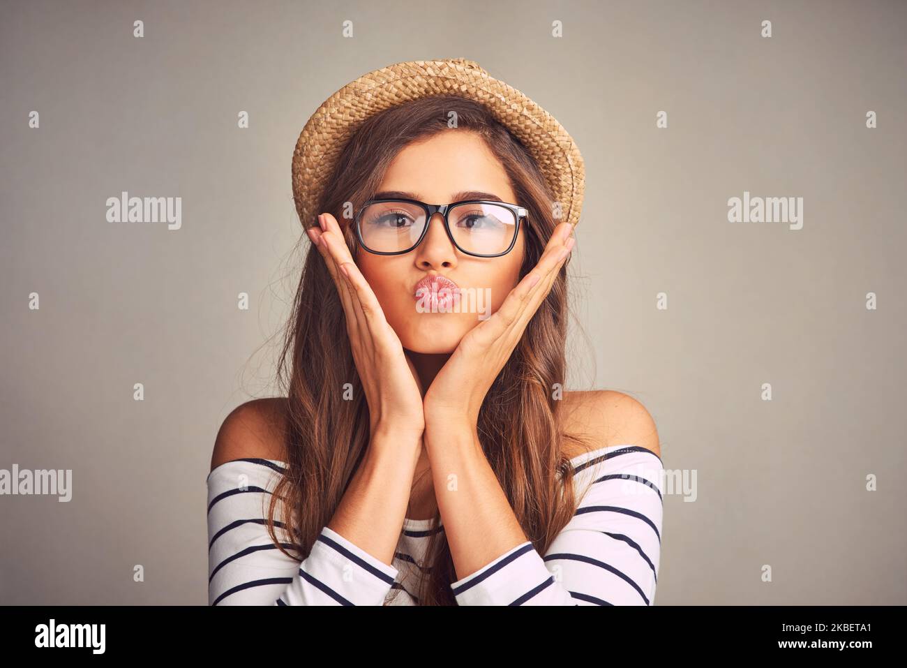 So much cuteness to her quirky side. Studio portrait of an attractive ...