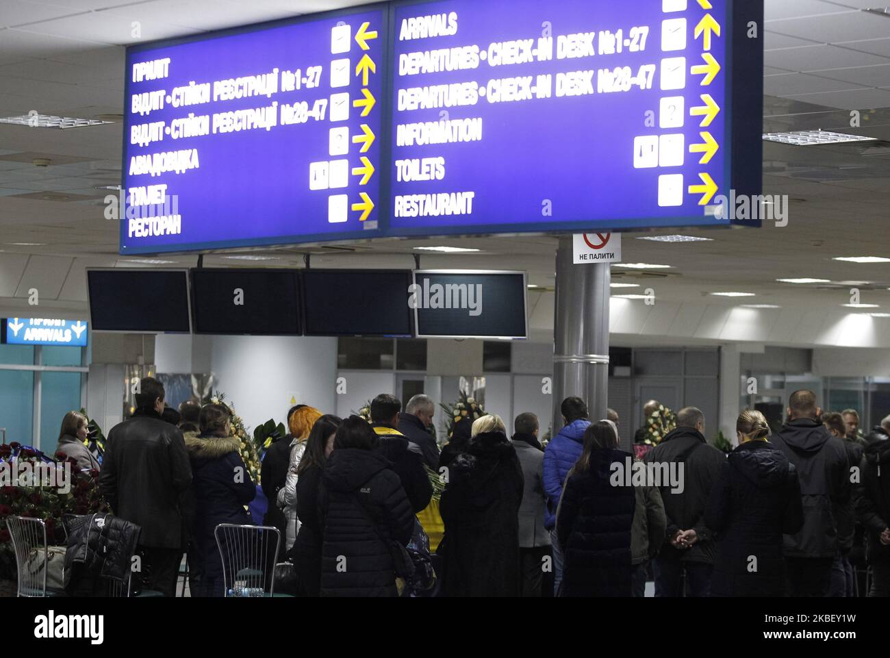 Relatives friends and collegues stand next to coffins of Ukrainians ...