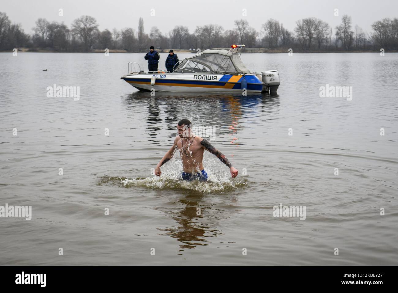 People walk into icy waters to take a dip during celebrations of the ...