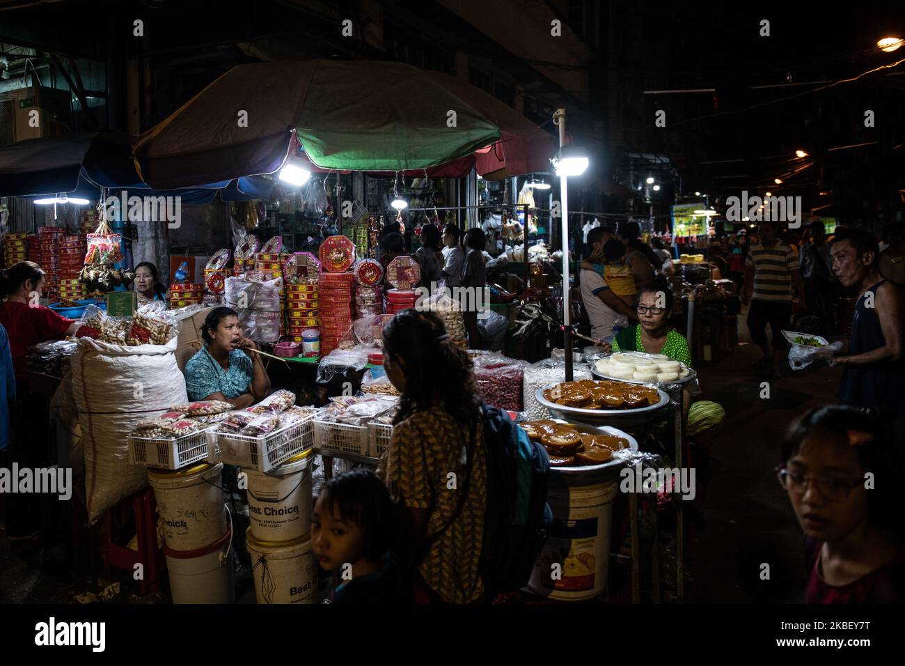 People walk around the bazaar at Chinatown district in Yangon, Myanmar ...