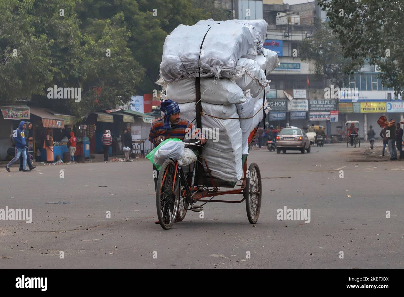 A labour carry goods on a hand cart in New Delhi India on 19 January ...