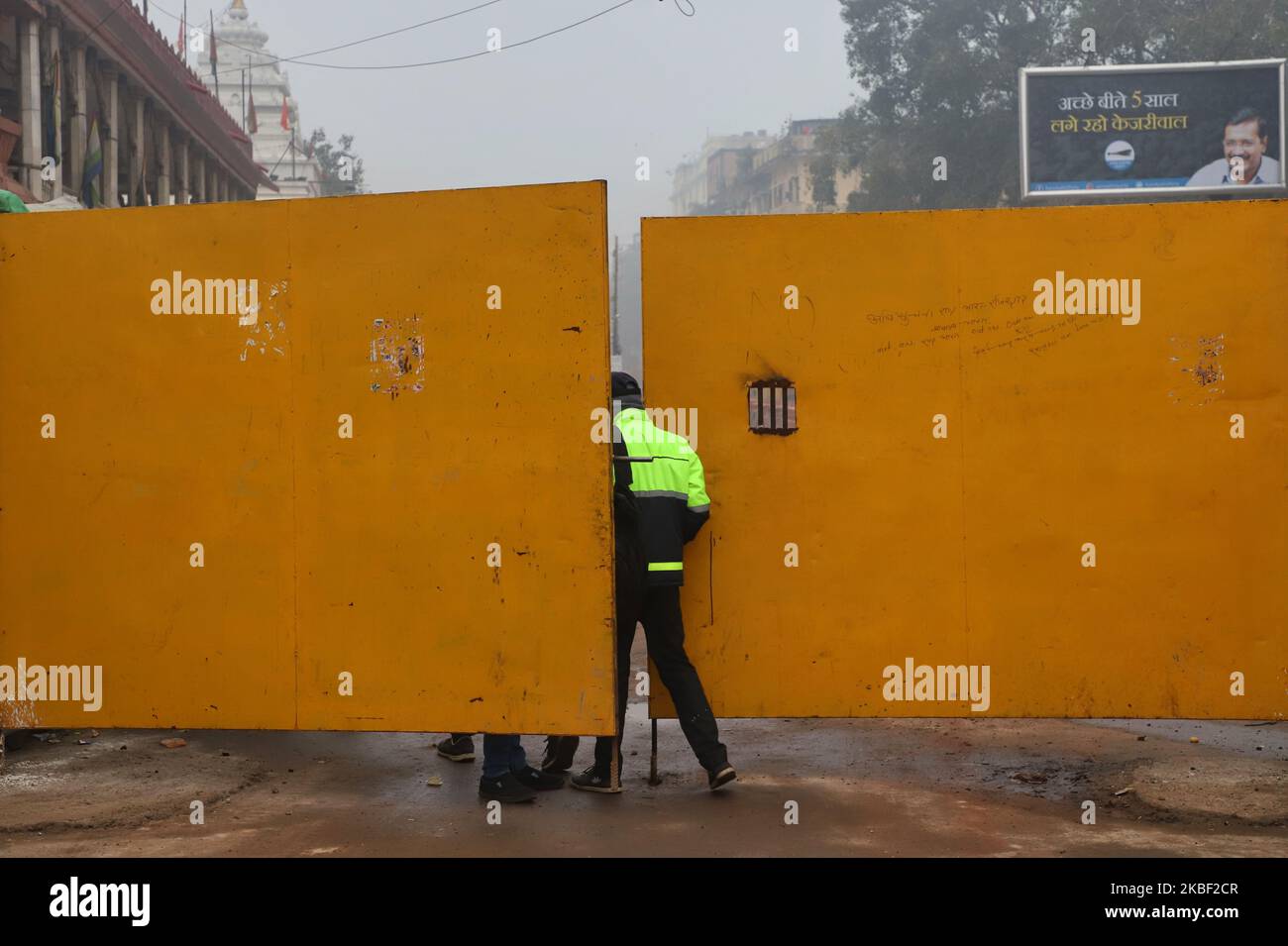 A worker enters the Gate at a construction site in Old Delhi, India on ...