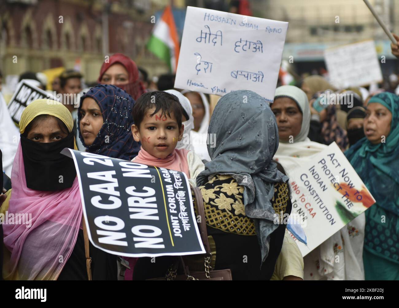 Protesters hold placards, posters, banners and Indian flags on a ...