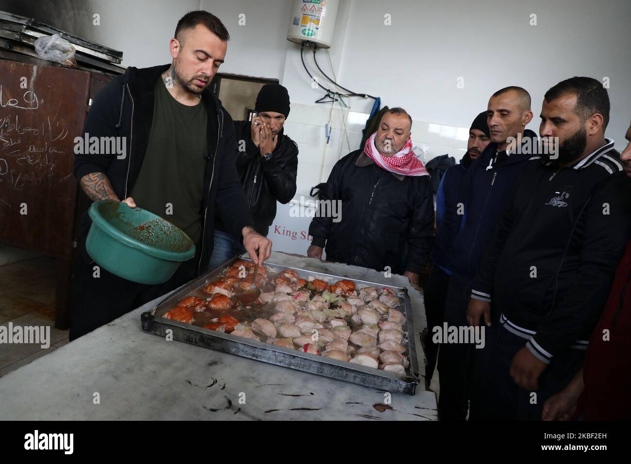 Gabriele Rubini (L), known as Chef Rubio, cooks with Palestinian ...