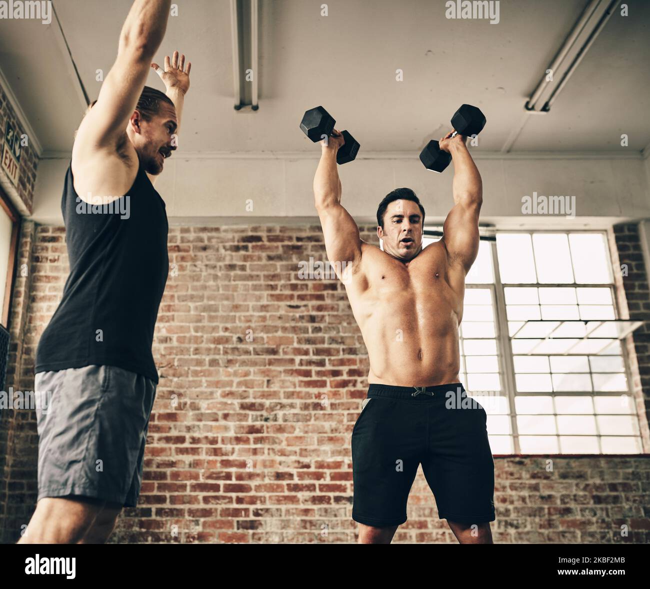 Just follow my lead. two fit and determined young men helping each ...