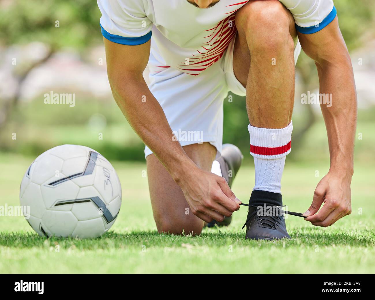 Sports, soccer and man tie shoe on field, ready for game, match and ...