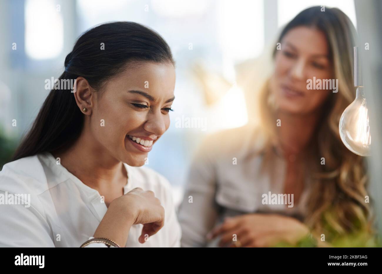 I was very fortunate. two young businesswomen talking to each other ...
