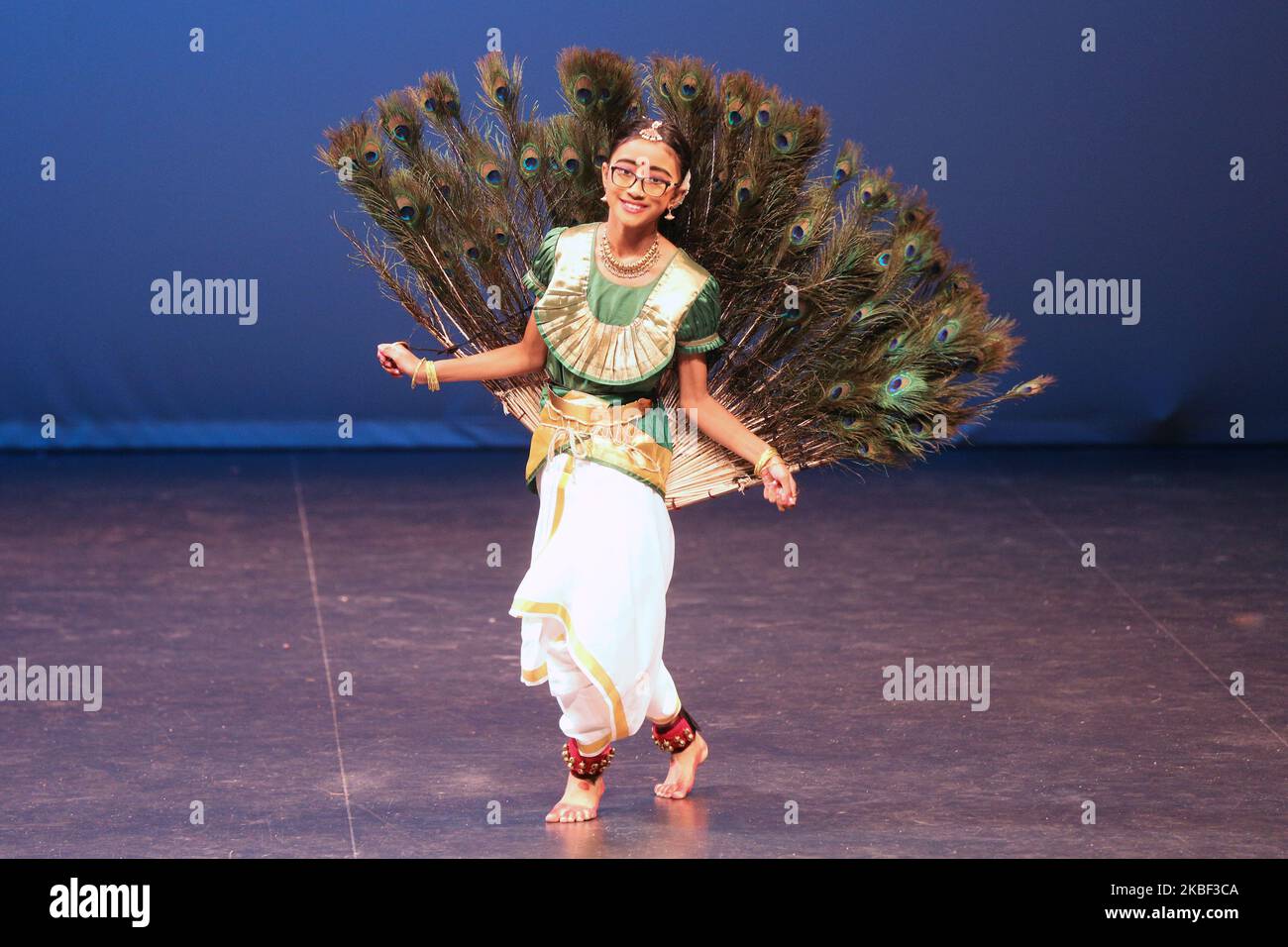 Tamil girl performs a traditional peacock dance during a cultural ...