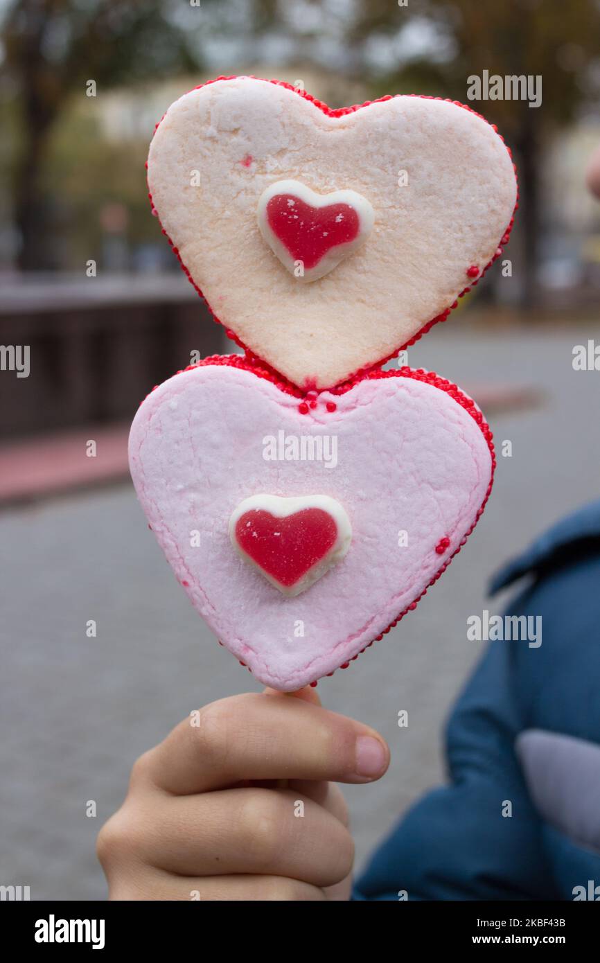 holds two candy cards in the hands of a stick Stock Photo - Alamy