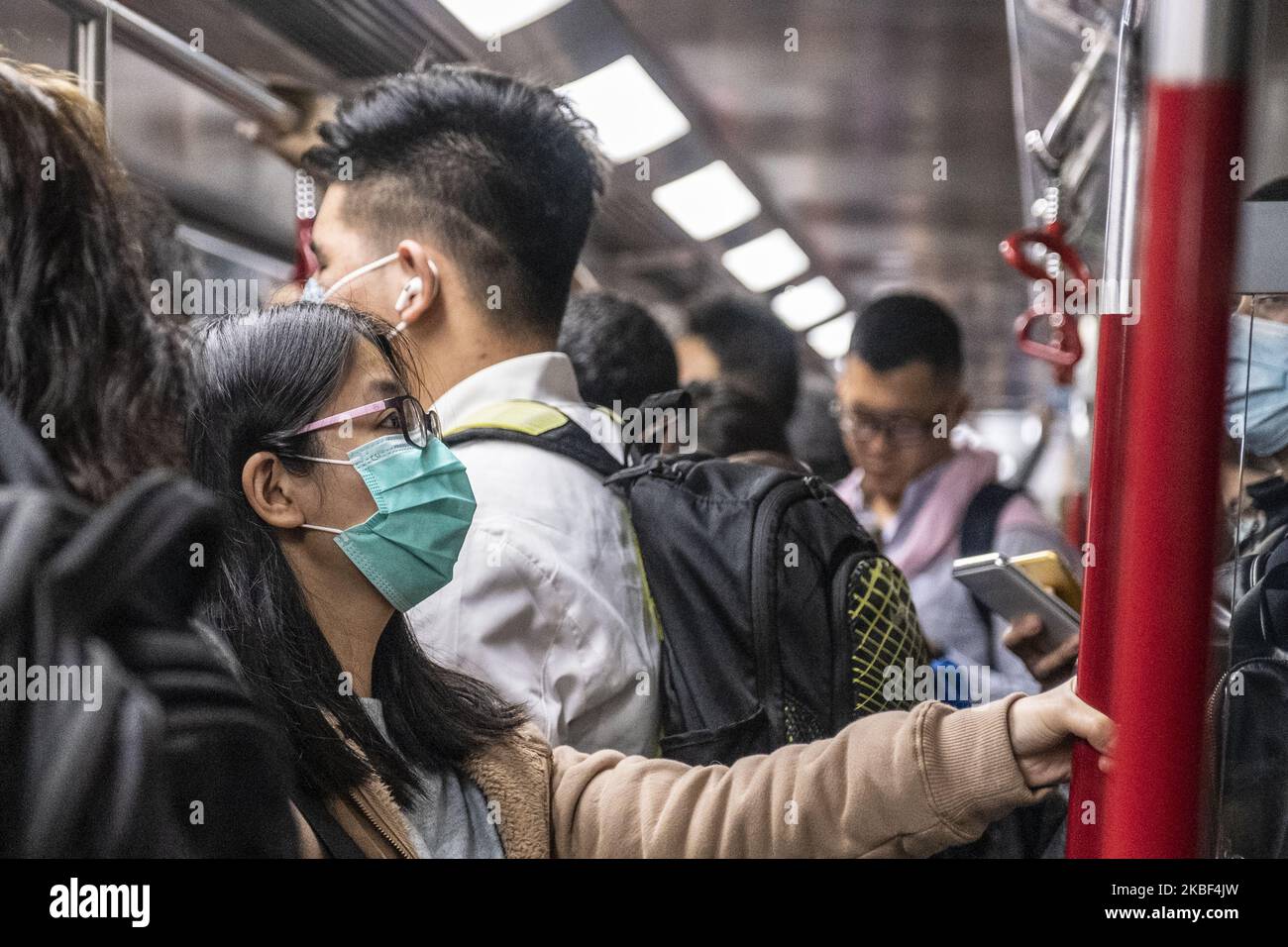 A Women wears a mask as she rides the MTR train on January 22, 2019 in ...