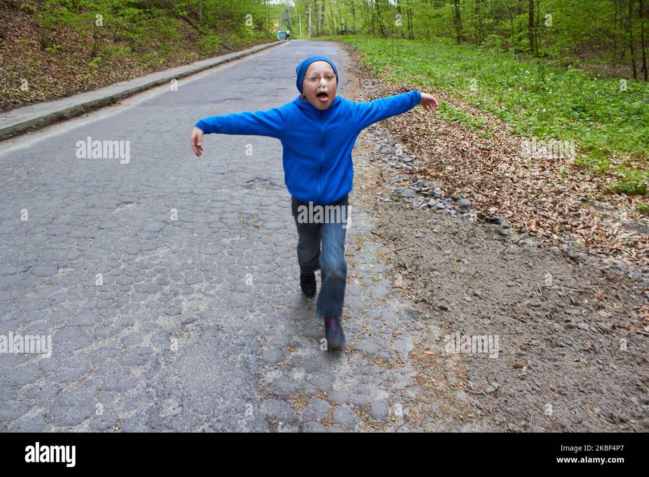 in autumn the boy runs on the road with open arms for hugs Stock Photo ...