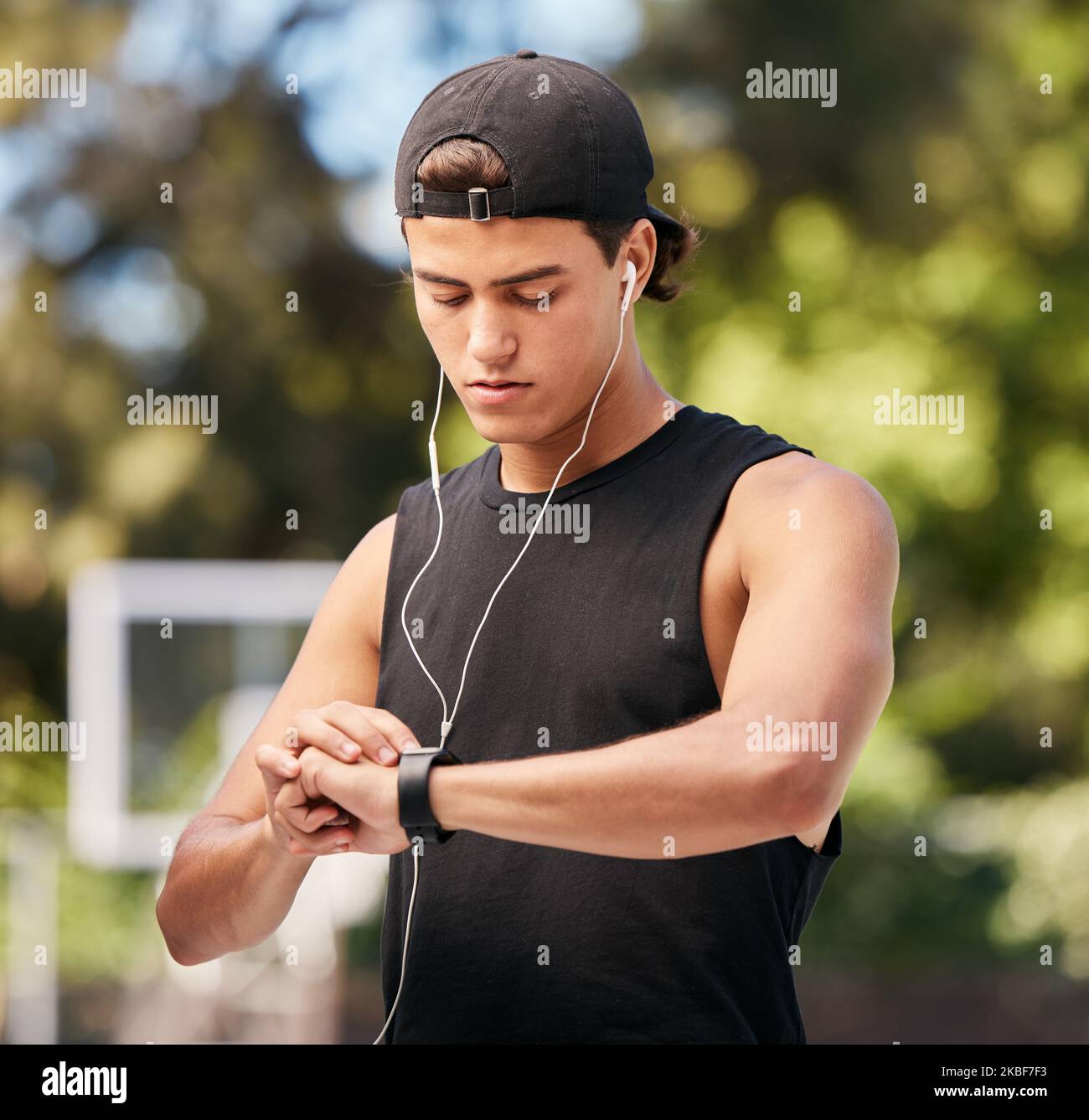 Fitness, smartwatch and sports man listening to music with earphones ...