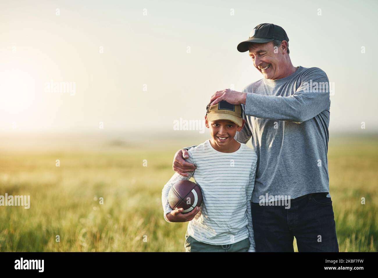 Our days of play are the best. father and son playing with a football ...