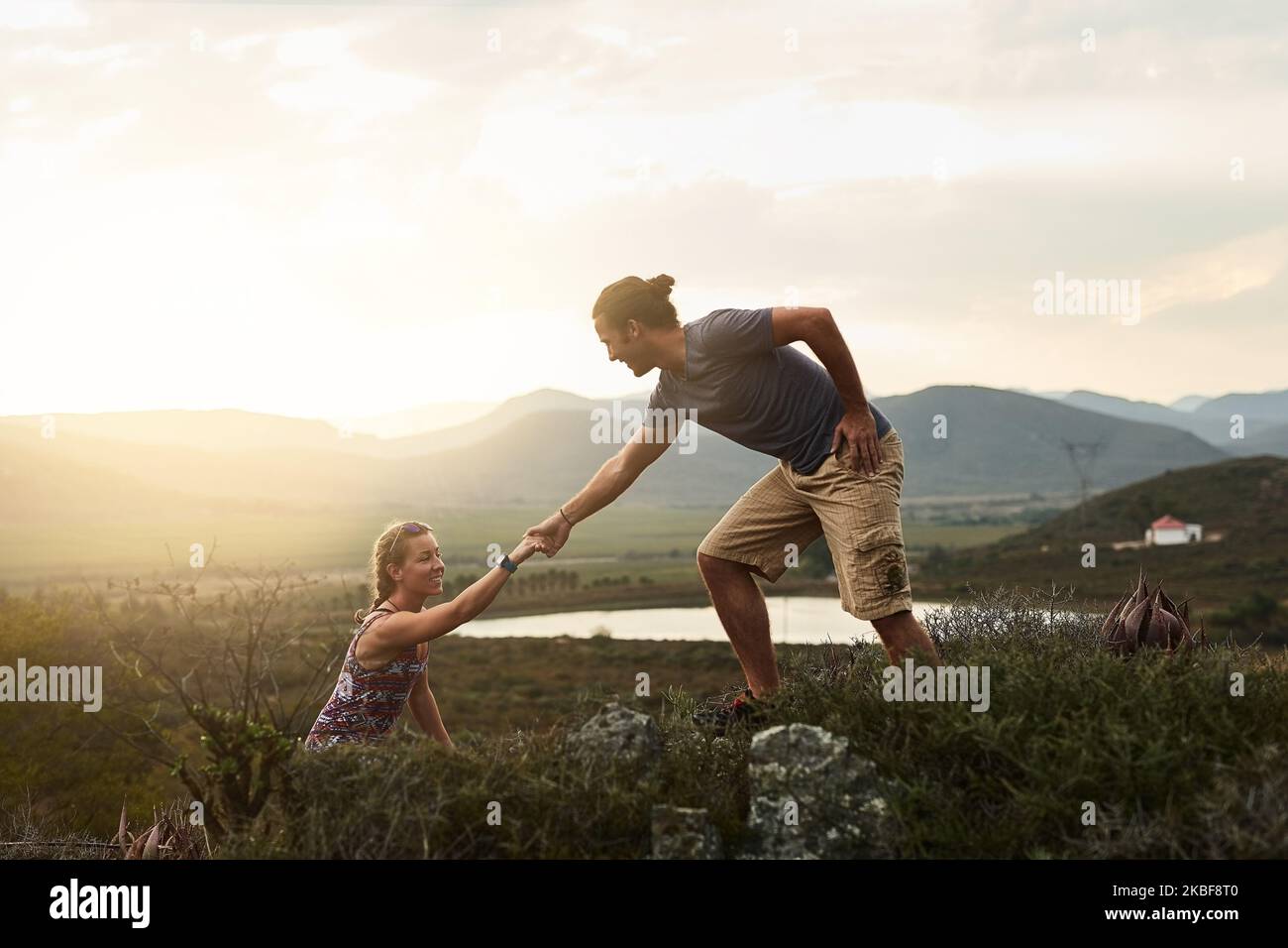 Nature brings out the best in everyone. a friendly young hiker helping ...