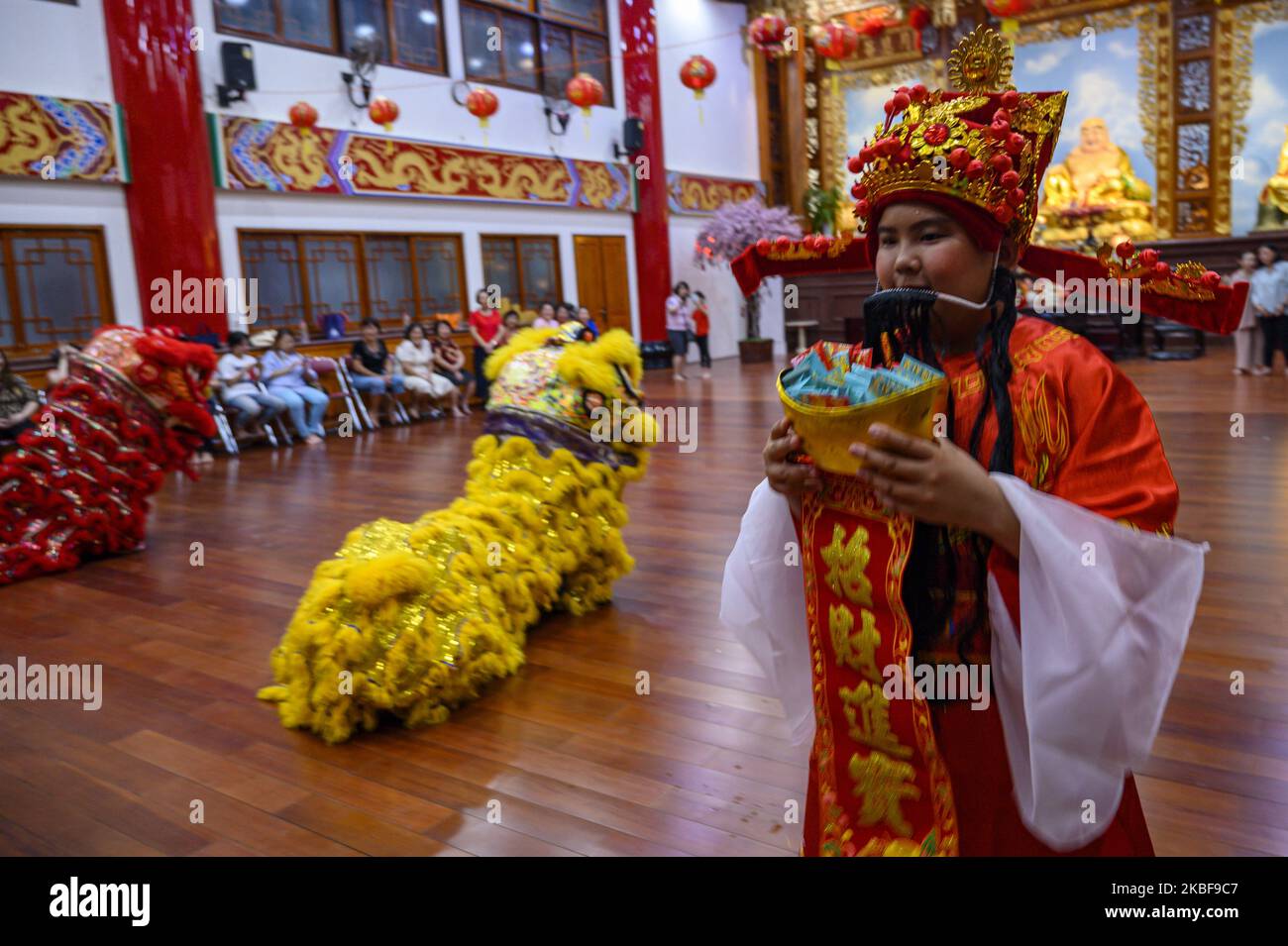 A Chinese citizen wearing traditional clothing during the lion dance ...