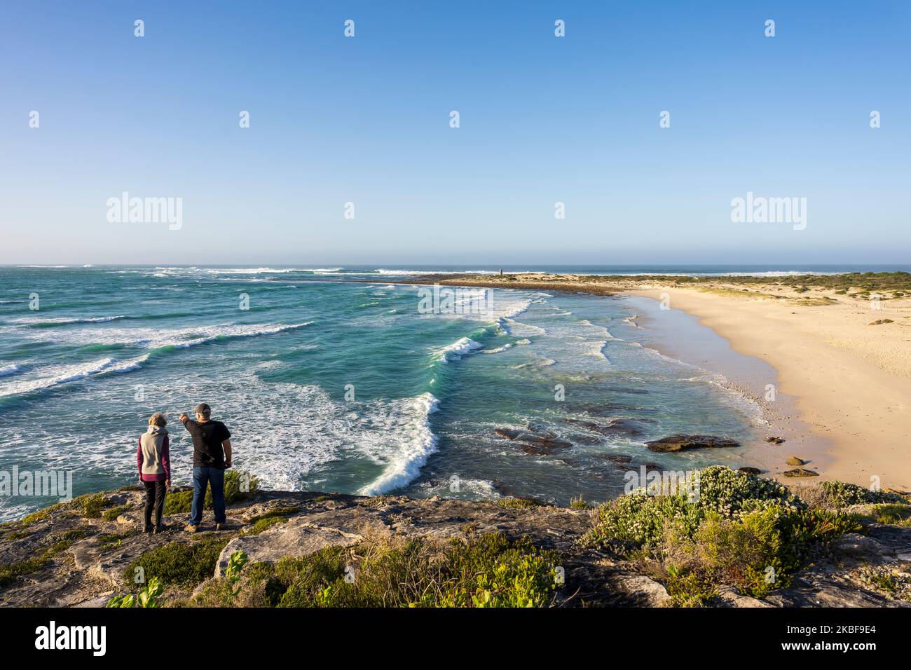 Tourists admire views of Struispunt and Saxon Reef from sea cliffs near ...