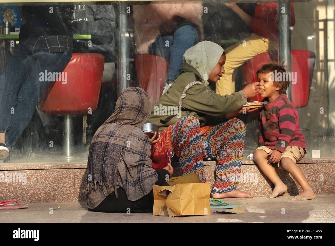 Poor girl feeds brother hi-res stock photography and images - Alamy