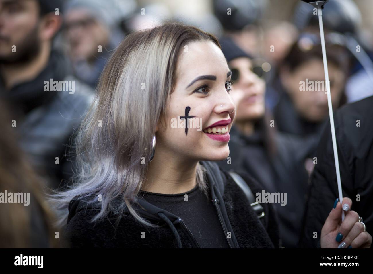 A woman is portrayed with the sign of the cross on her cheek in Rome ...