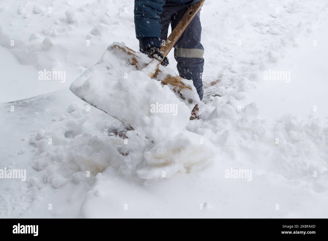 shoveling snow shovel in hand winter boy Stock Photo - Alamy