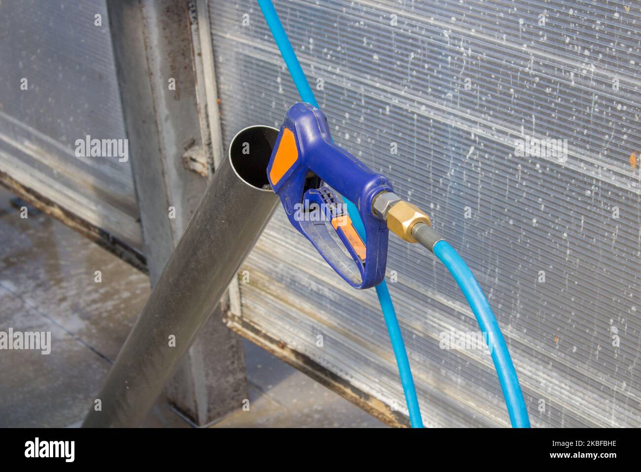 Blue car wash using high pressure water jet Stock Photo - Alamy