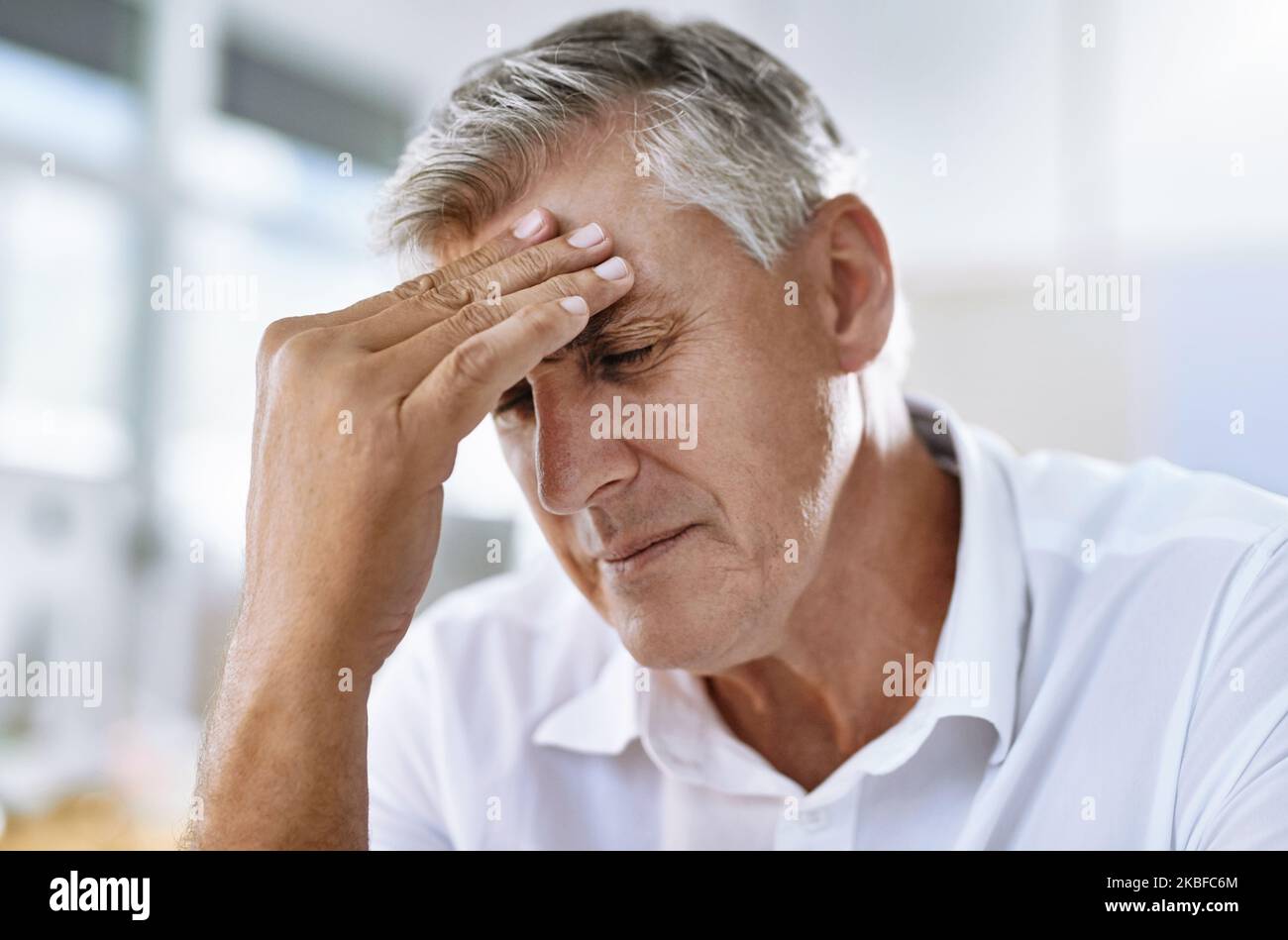 Struggling to concentrate with this headache. a mature businessman ...