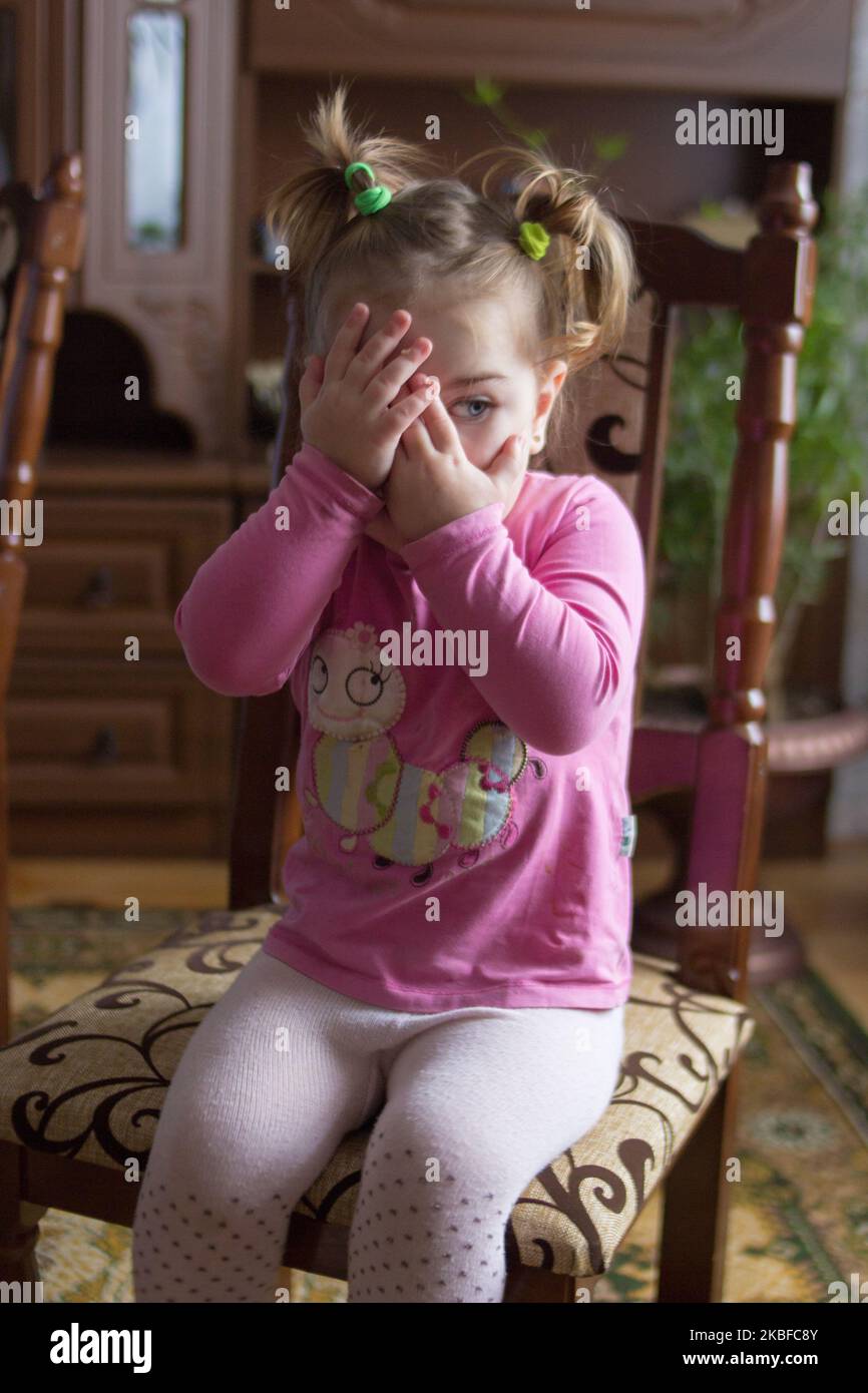 Village little girl closed her hands face Stock Photo - Alamy