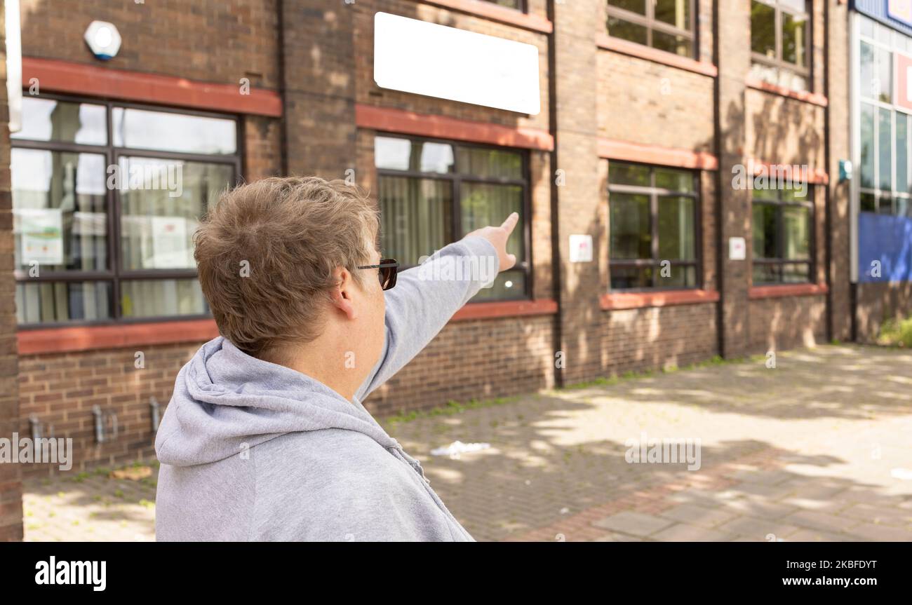 Caucasian women in a grey hoody and sunglasses looking forward and ...