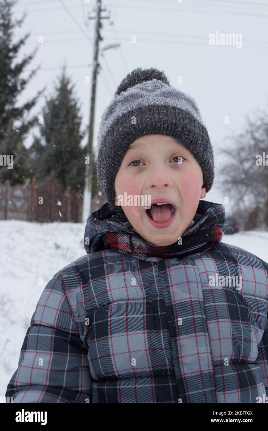 A funny boy discovered his mouth in winter Stock Photo - Alamy