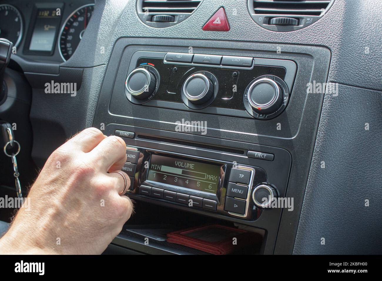 Men hand turns the radio in the car Stock Photo - Alamy
