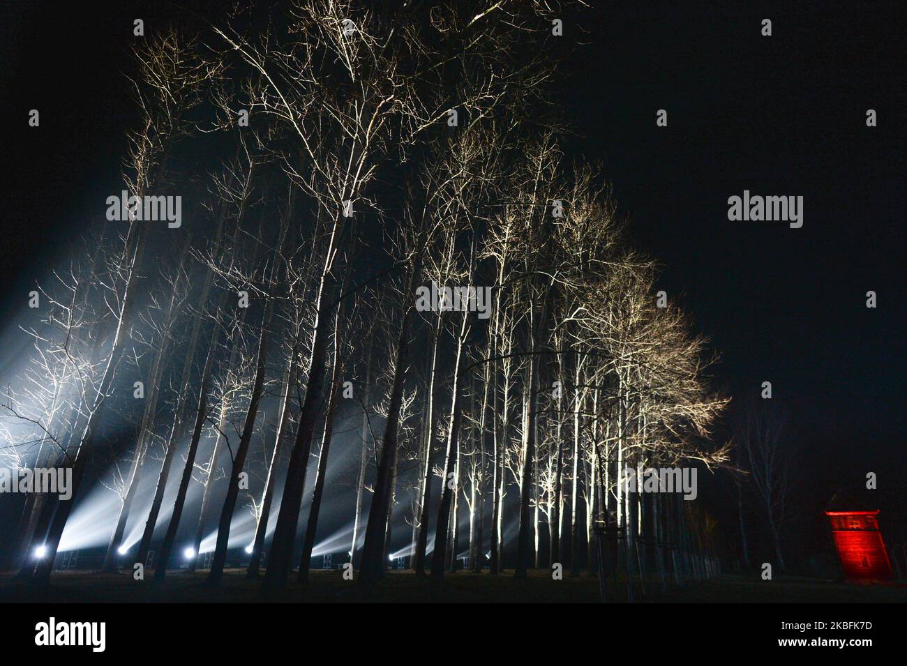 Guard tower and trees stand on the illuminated grounds of the former ...