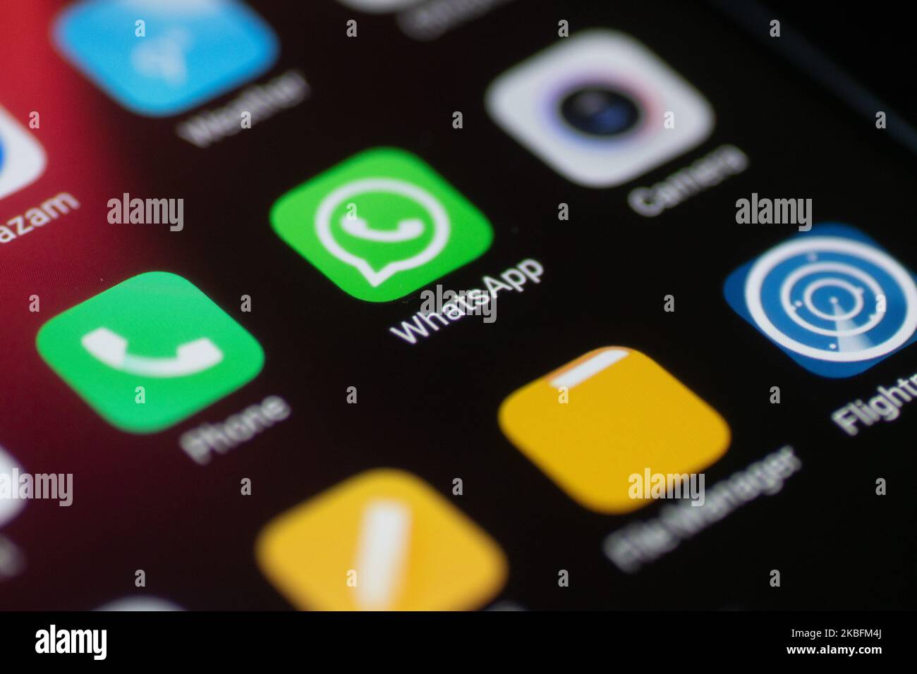 WhatsApp logo displayed on a phone screen, smartphone and keyboard are ...