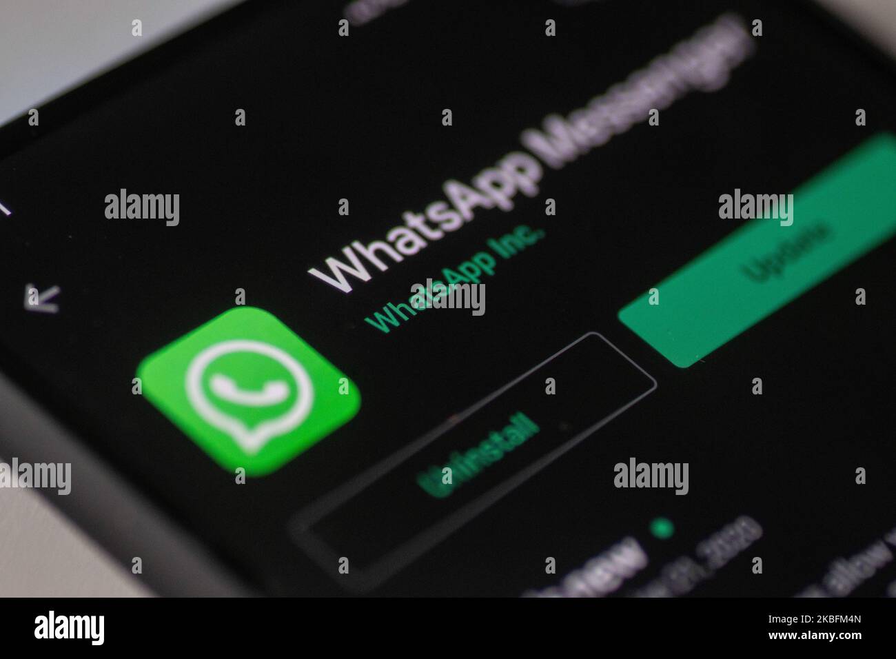 WhatsApp logo displayed on a phone screen, smartphone and keyboard are ...