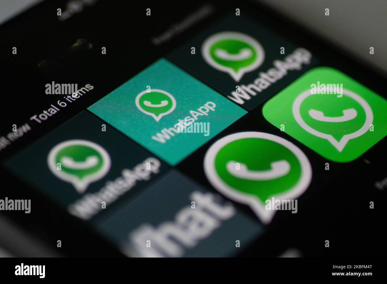 WhatsApp logo displayed on a phone screen, smartphone and keyboard are ...