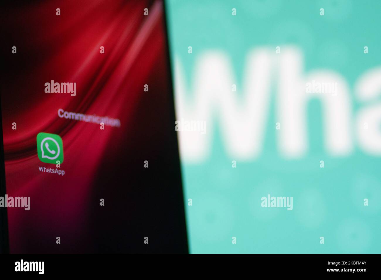 WhatsApp logo displayed on a phone screen, smartphone and keyboard are ...
