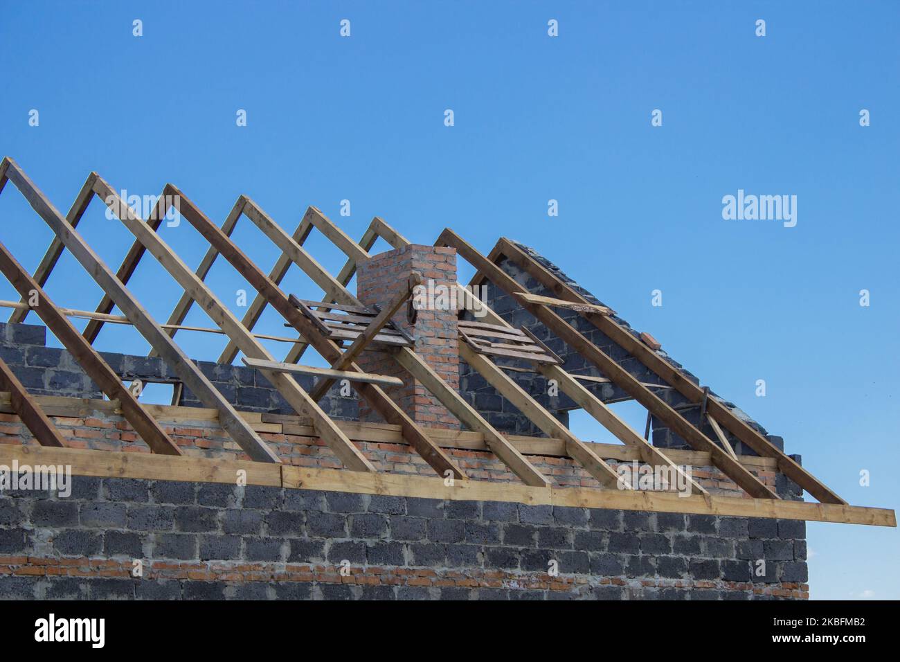 Wooden rafters against the blue sky house Stock Photo - Alamy