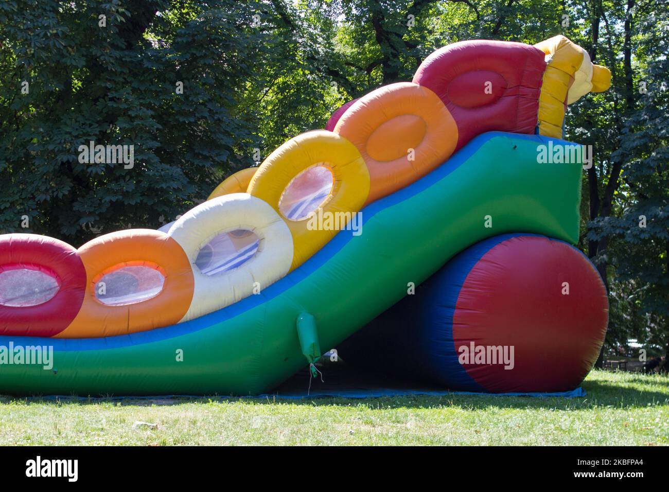 children's water slides in the park near trees Stock Photo - Alamy