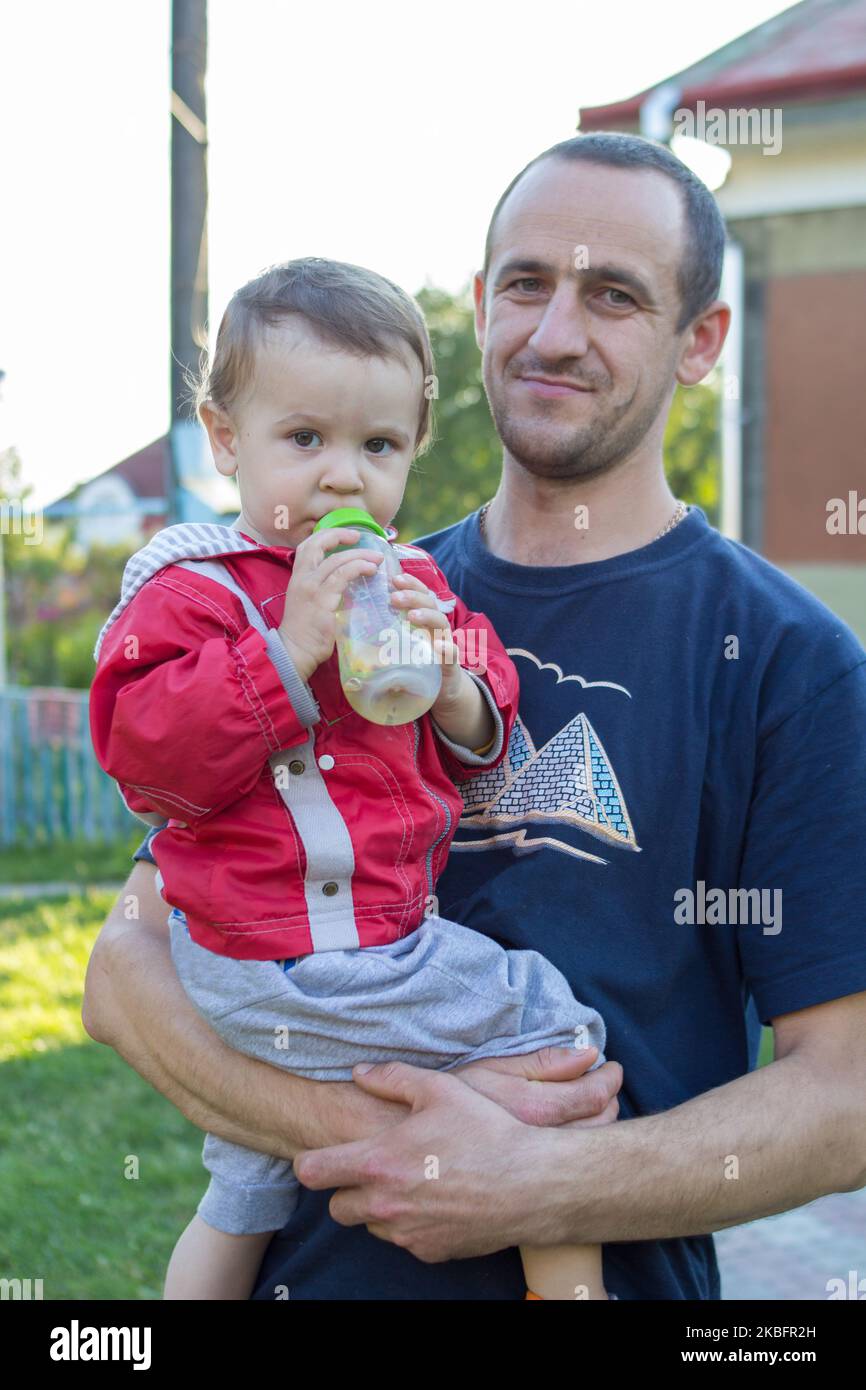 bearded father holding his son on his hands Stock Photo - Alamy