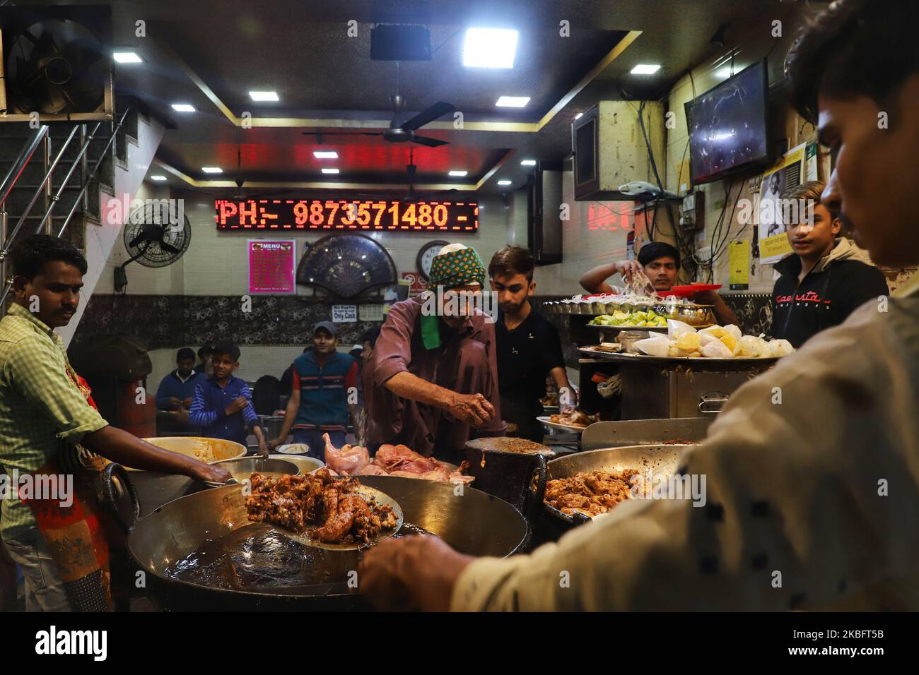A chef fries chicken pieces at a Non-Veg restaurant outside the Jama ...