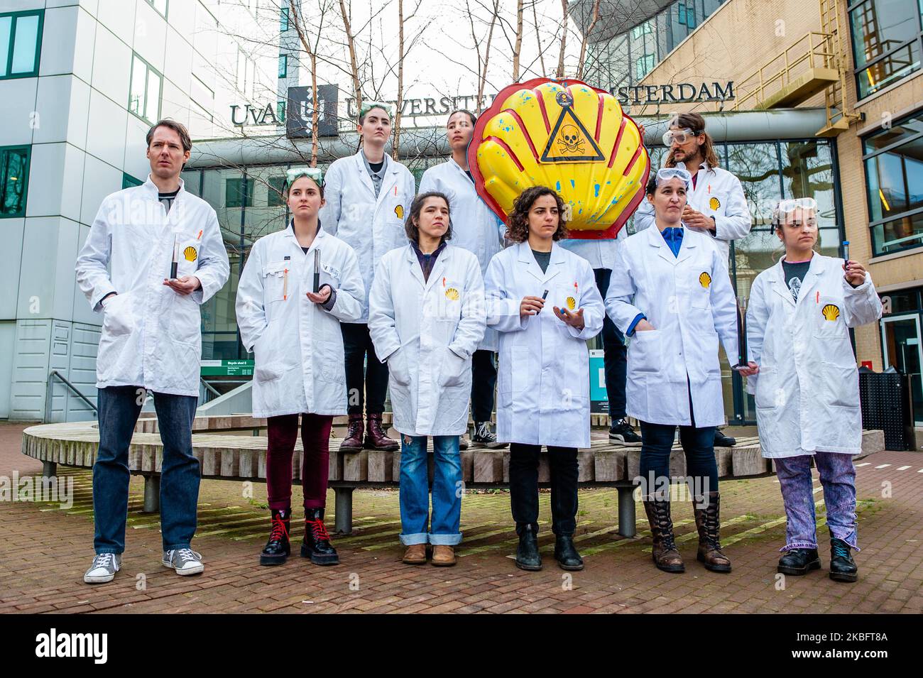A group of activists are posing in front of the University of Amsterdam ...