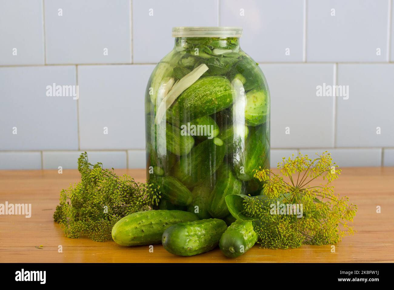 on the table fresh cucumbers pickled in a jar Stock Photo - Alamy