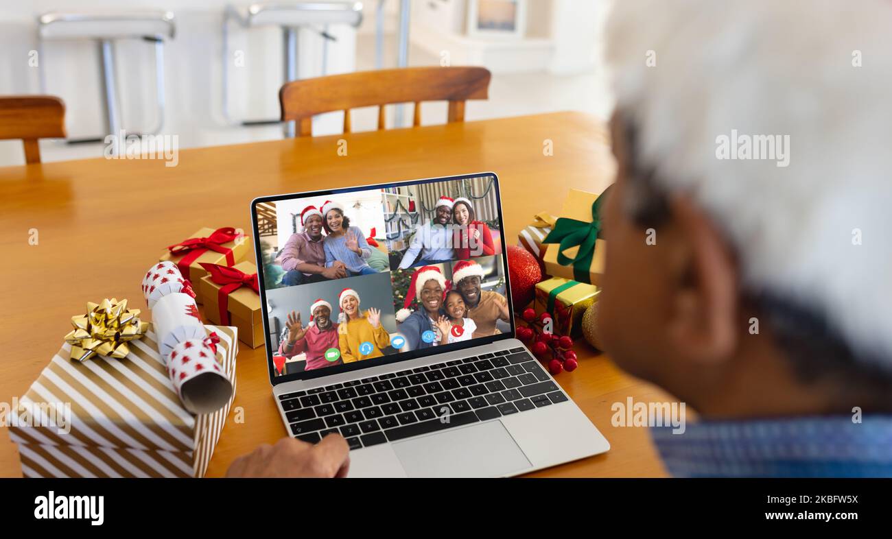 Biracial man with santa hat having video call with happy diverse ...