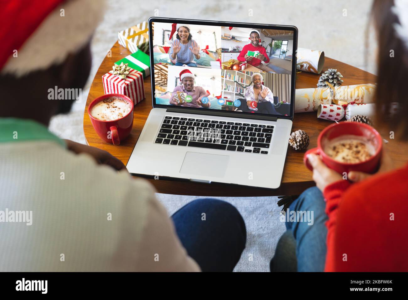 Diverse couple with christmas decorations having video call with happy ...