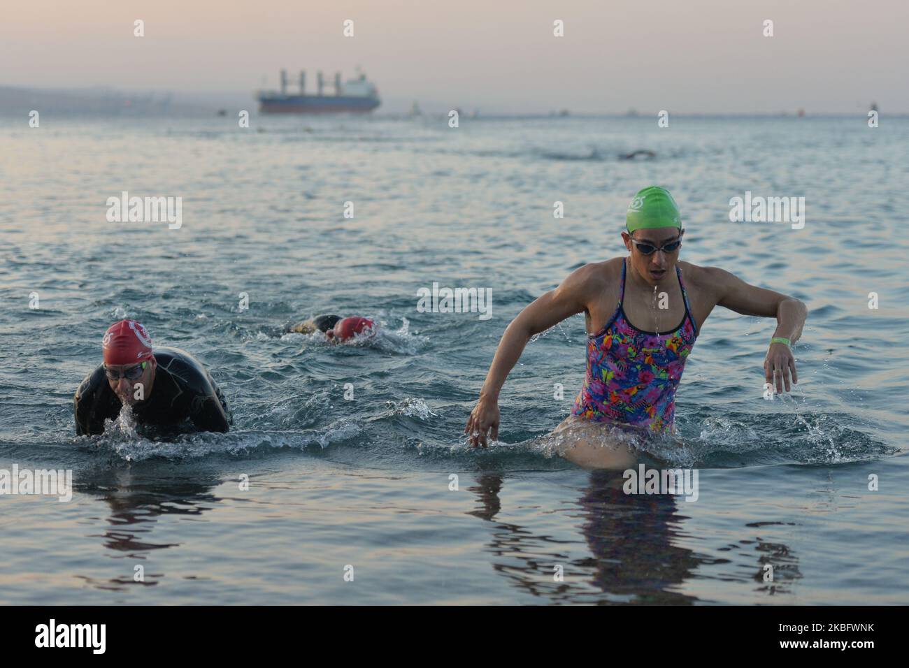 Athletes finishing their swim in the Red Sea during a full Ironman ...