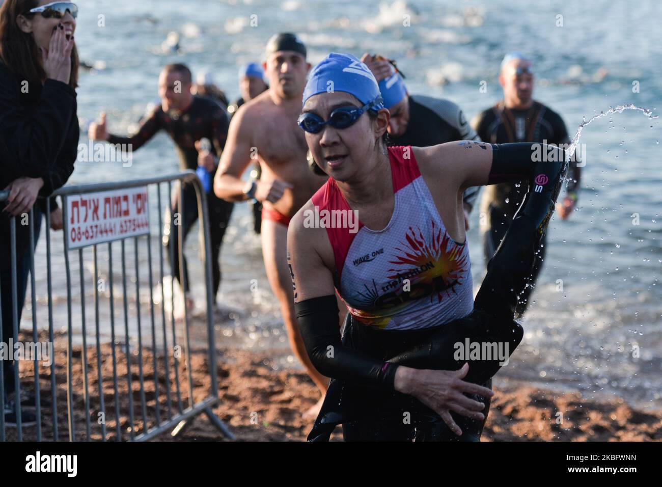 Athletes finishing their swim in the Red Sea during a full Ironman ...